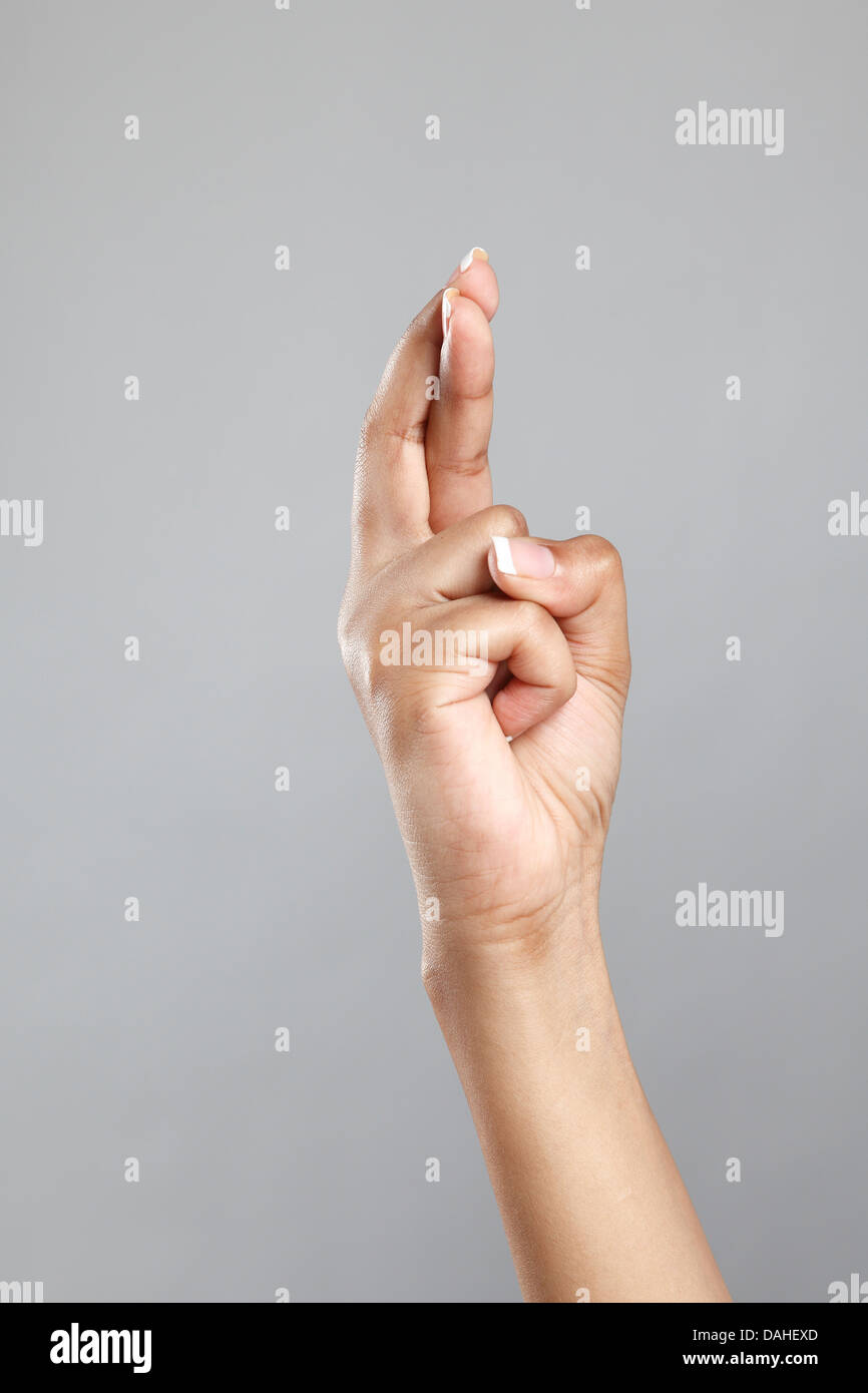 Woman's hand with crossed fingers Stock Photo - Alamy