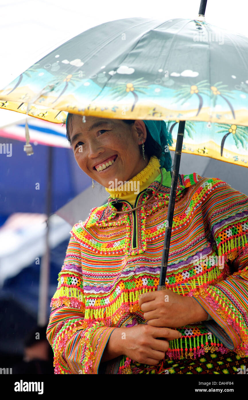 Flower Hmong woman peering from underneath her umbrella. Bac Ha market ...