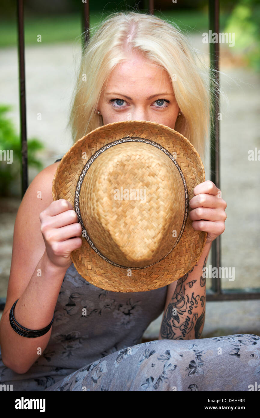 Young girl hiding behind hat Stock Photo - Alamy Young girl hiding behind hat Stock Photo - Alamy
