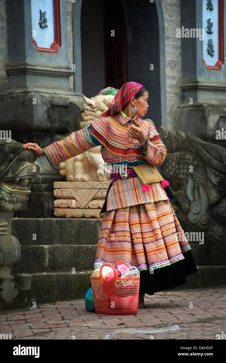 Flower Hmong woman in distinctive tribal costume at temple steps, Bac ...