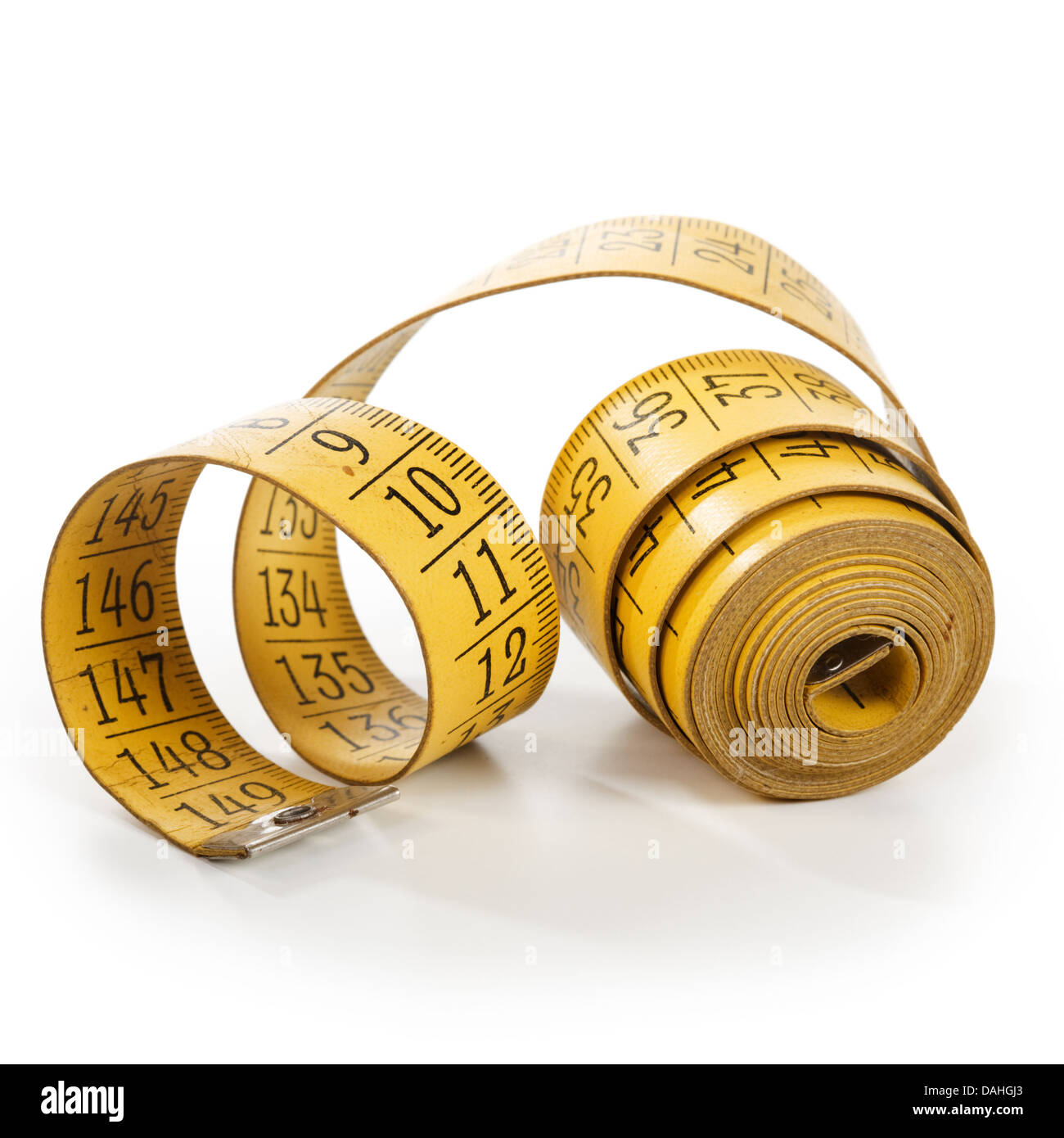 Close-up of yellow old tape measure on white background Stock Photo - Alamy