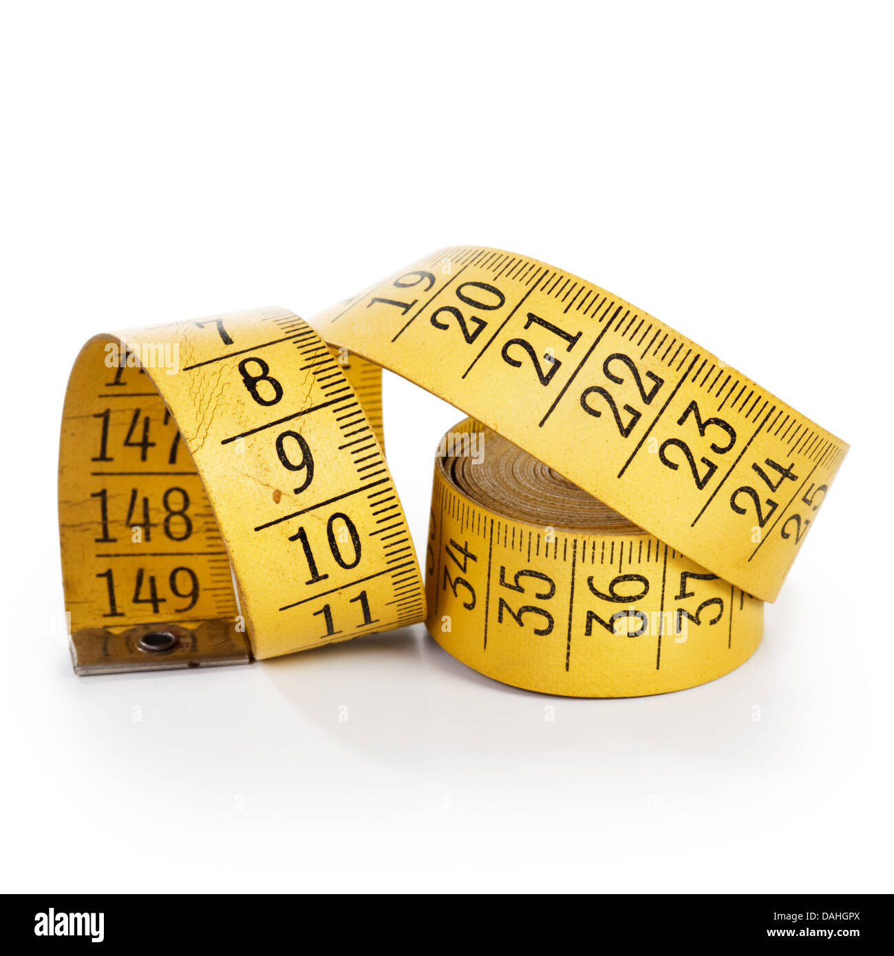 Close-up of yellow old tape measure on white background Stock Photo - Alamy