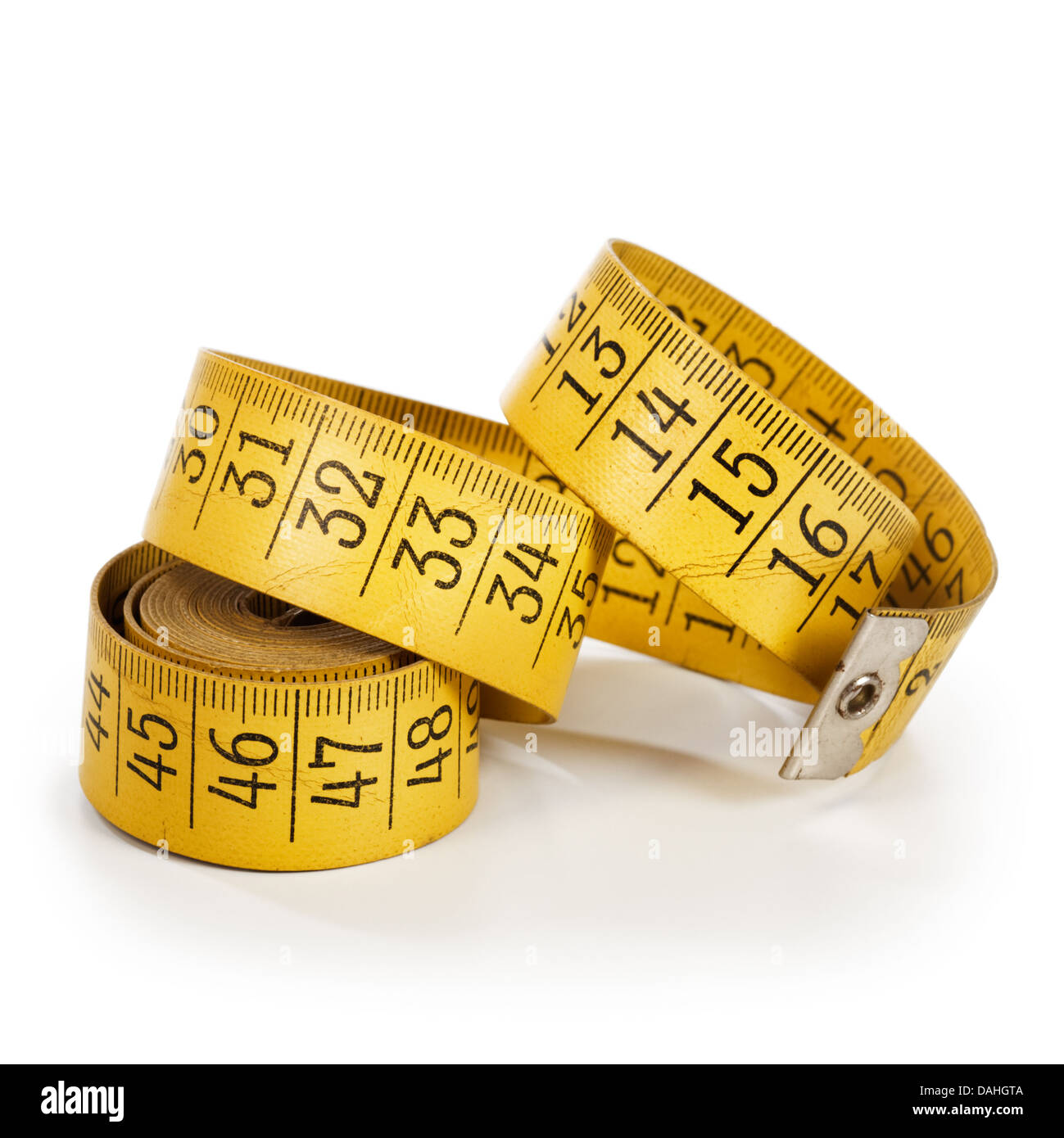 Close-up of yellow old tape measure on white background Stock Photo - Alamy