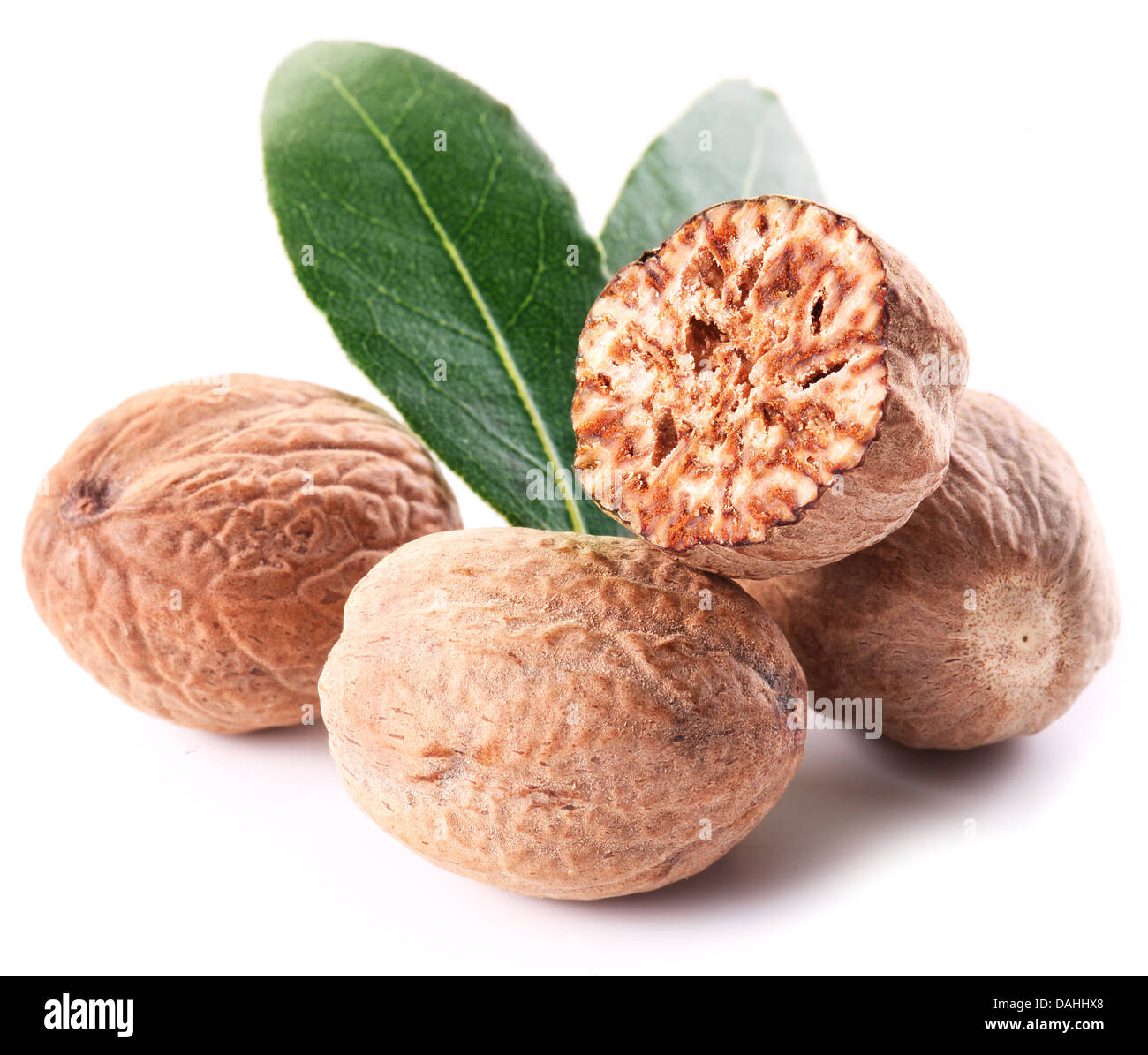Nutmeg with leaves on a white background Stock Photo - Alamy