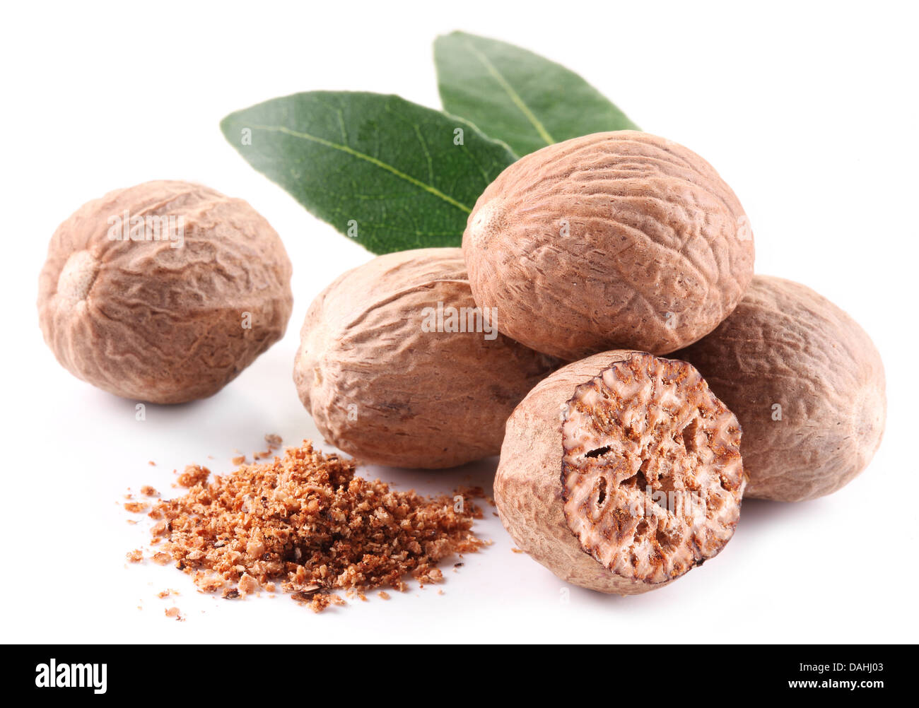 Nutmeg with leaves on a white background Stock Photo - Alamy