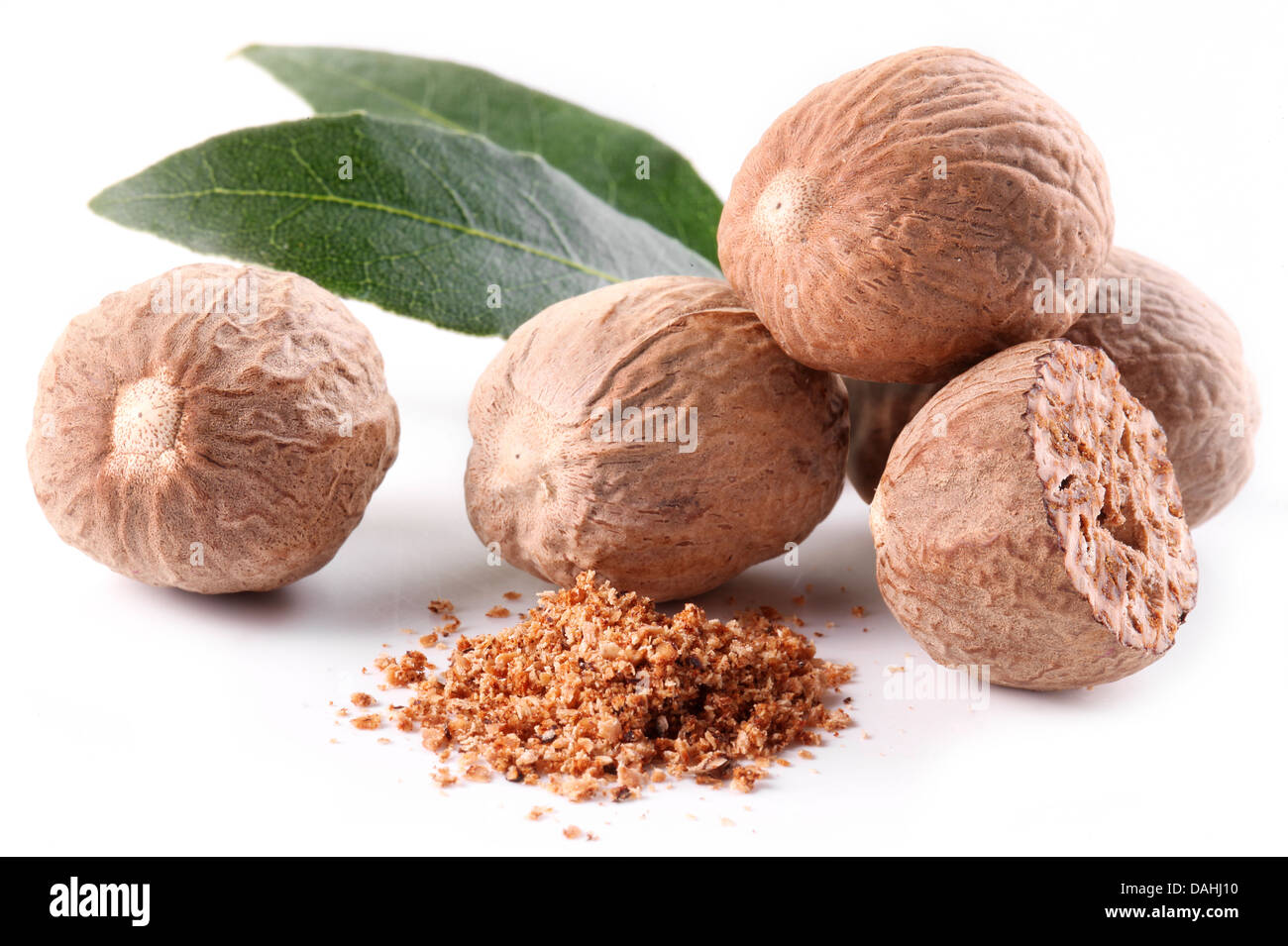 Nutmeg with leaves on a white background Stock Photo - Alamy