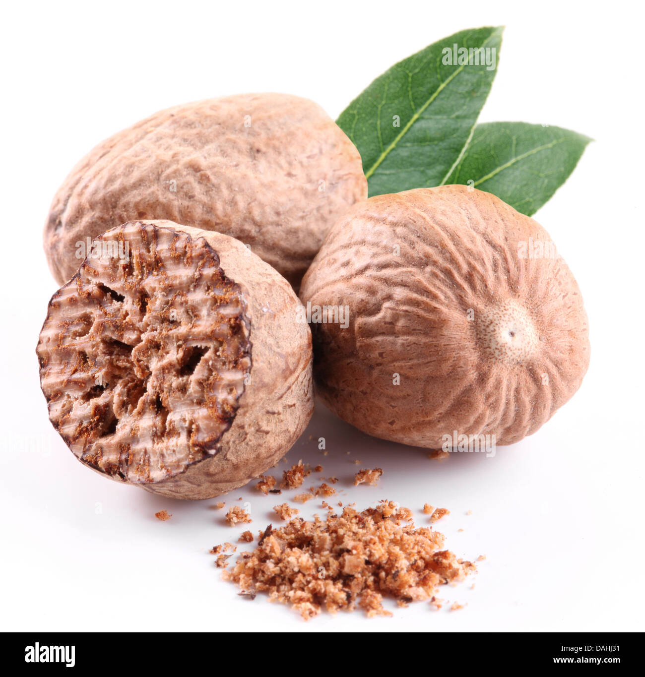 Nutmeg with leaves on a white background Stock Photo - Alamy