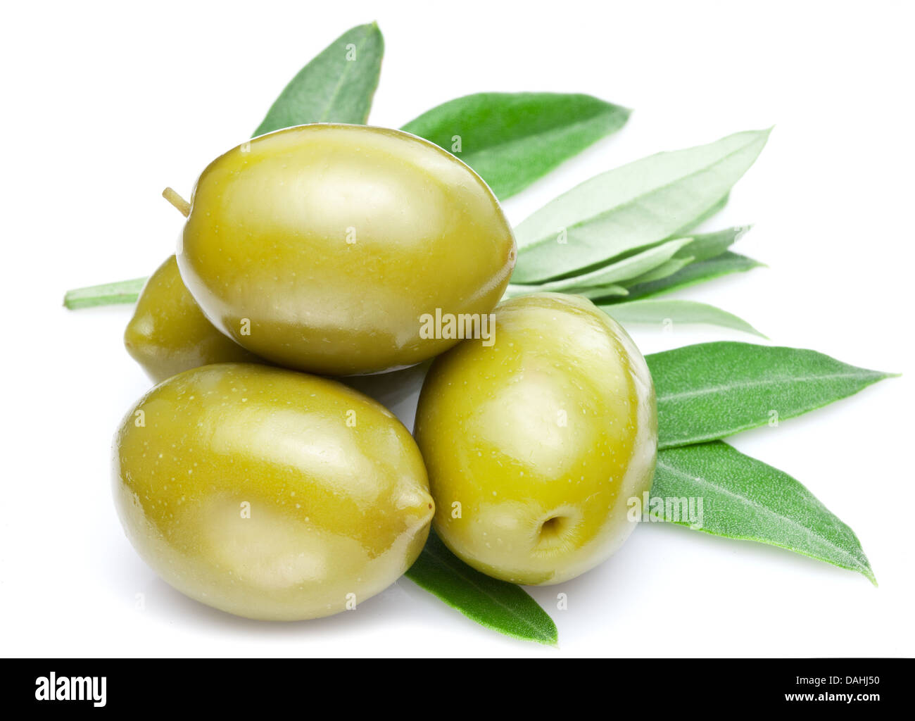 Green olives with leaves on a white background Stock Photo - Alamy