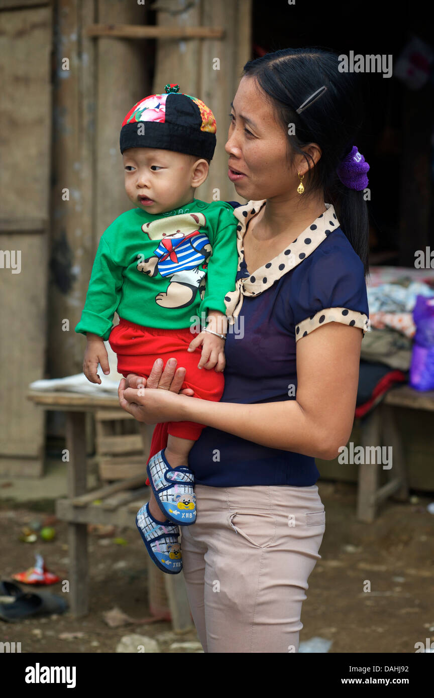 Vietnamese woman carrying young boy. Coc Toc village, Near Ba Be ...