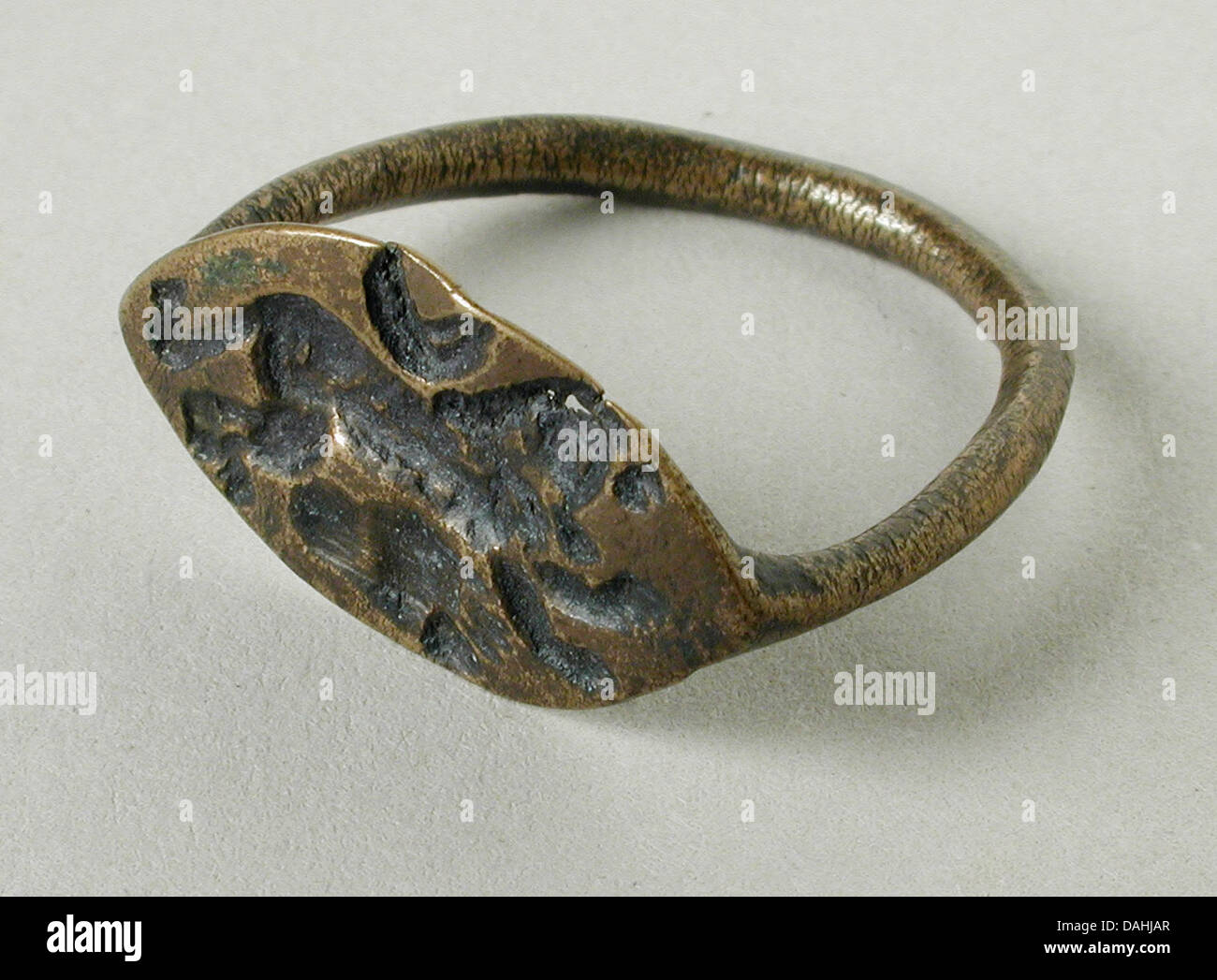 This ancient finger ring, made from bronze, features a detailed design ...