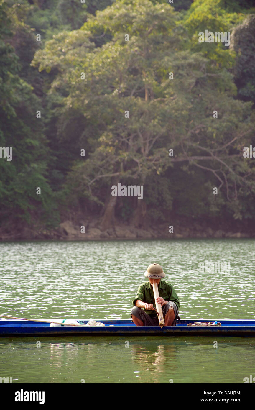 Fisherman smoking a water bong in a boat. Ba Be lake is the largest ...