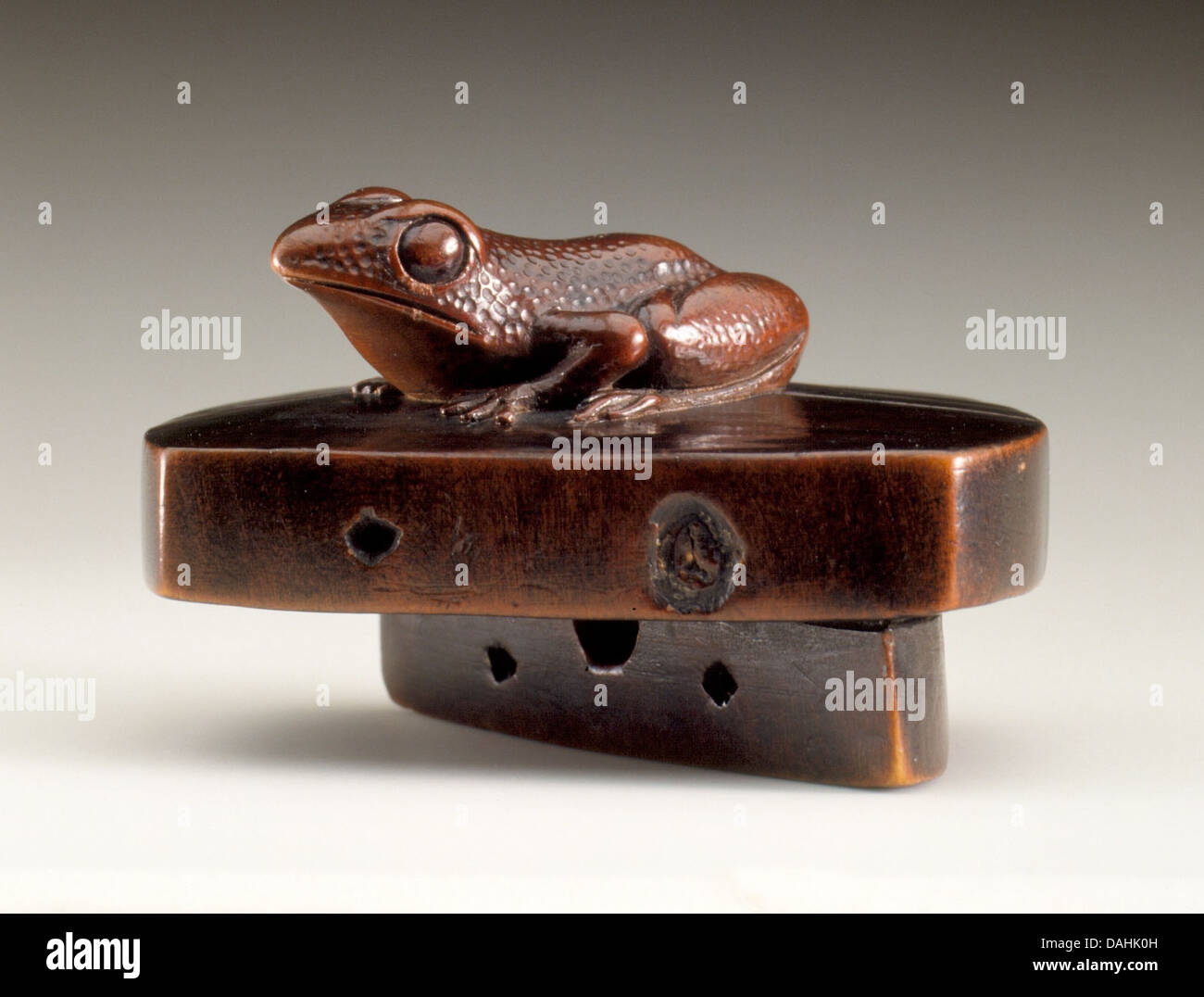 A bronze frog sculpture mounted on a well cover, part of the museum's ...