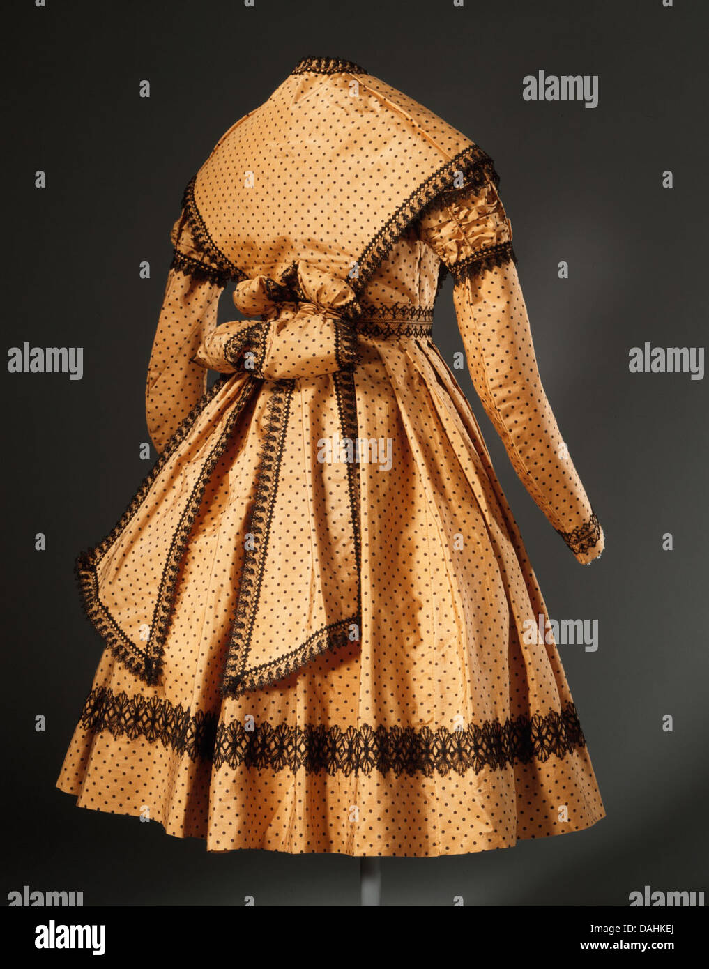 This girl's dress with a pelerine, a cape-like accessory, represents ...