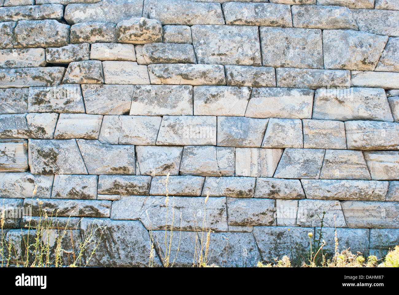 Ancient Greek structure on marble wall located on Delos island, Greece ...