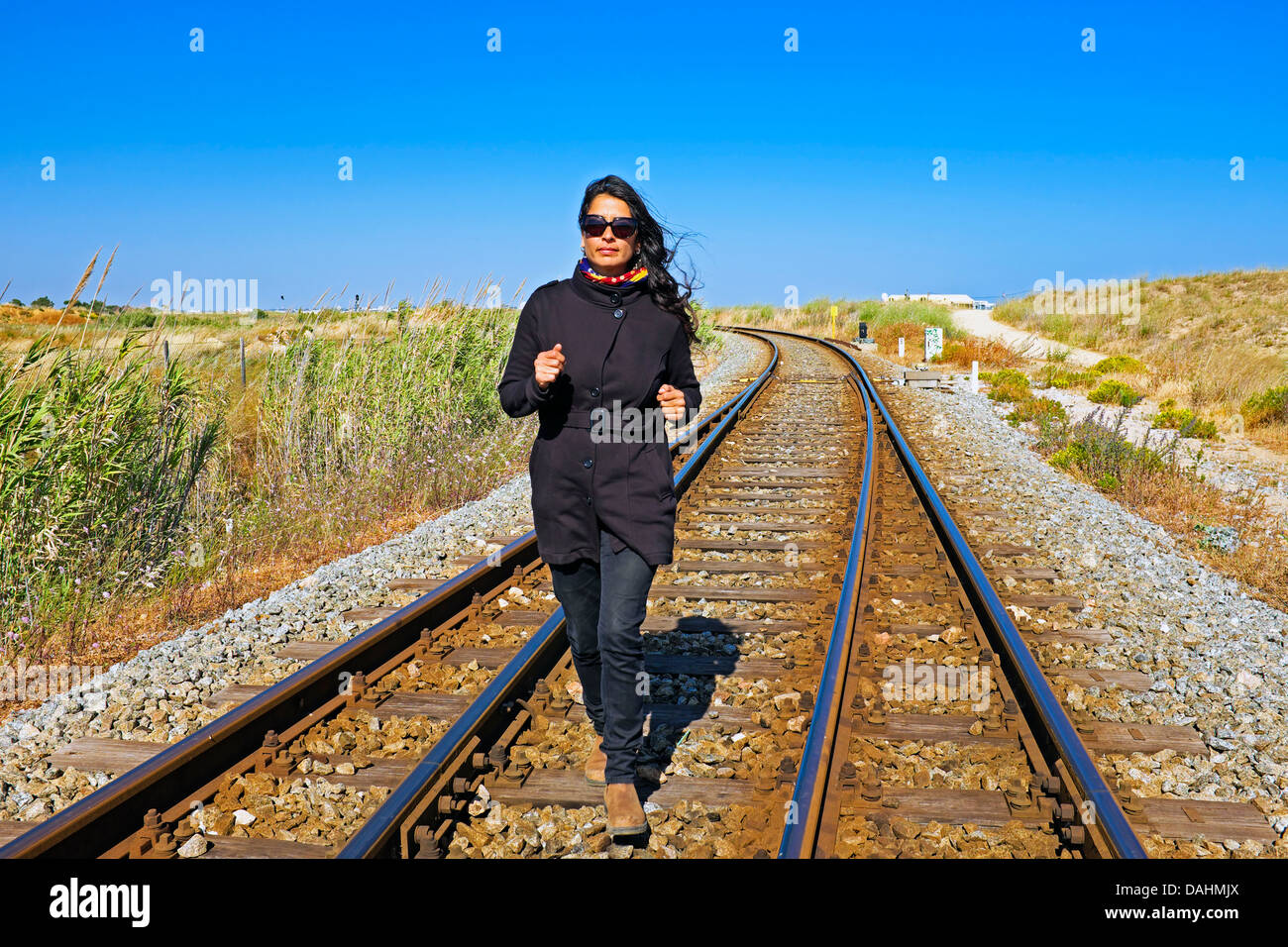 Young beautiful woman running on a railroad track Stock Photo - Alamy