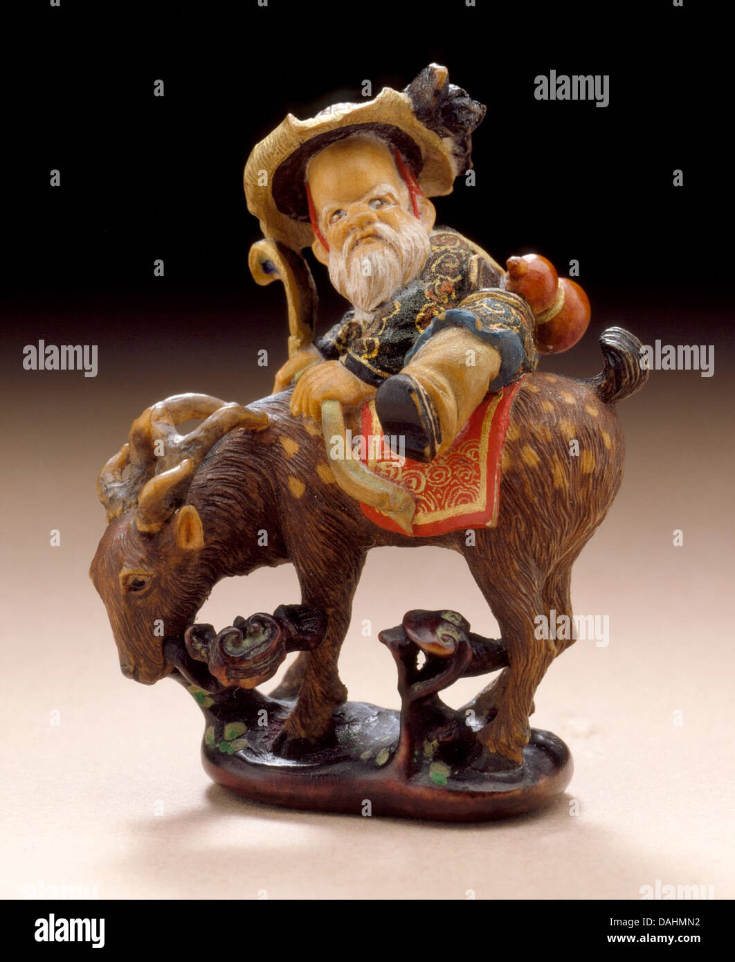 A bronze sculpture depicting Jurojin, the Japanese god of longevity ...