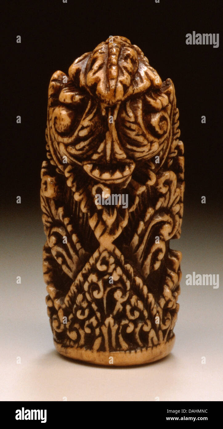 This Keris handle features intricate floral motifs and has been ...