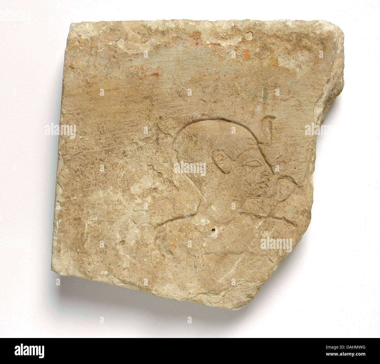 A carved limestone fragment depicting a royal figure, offering insight ...