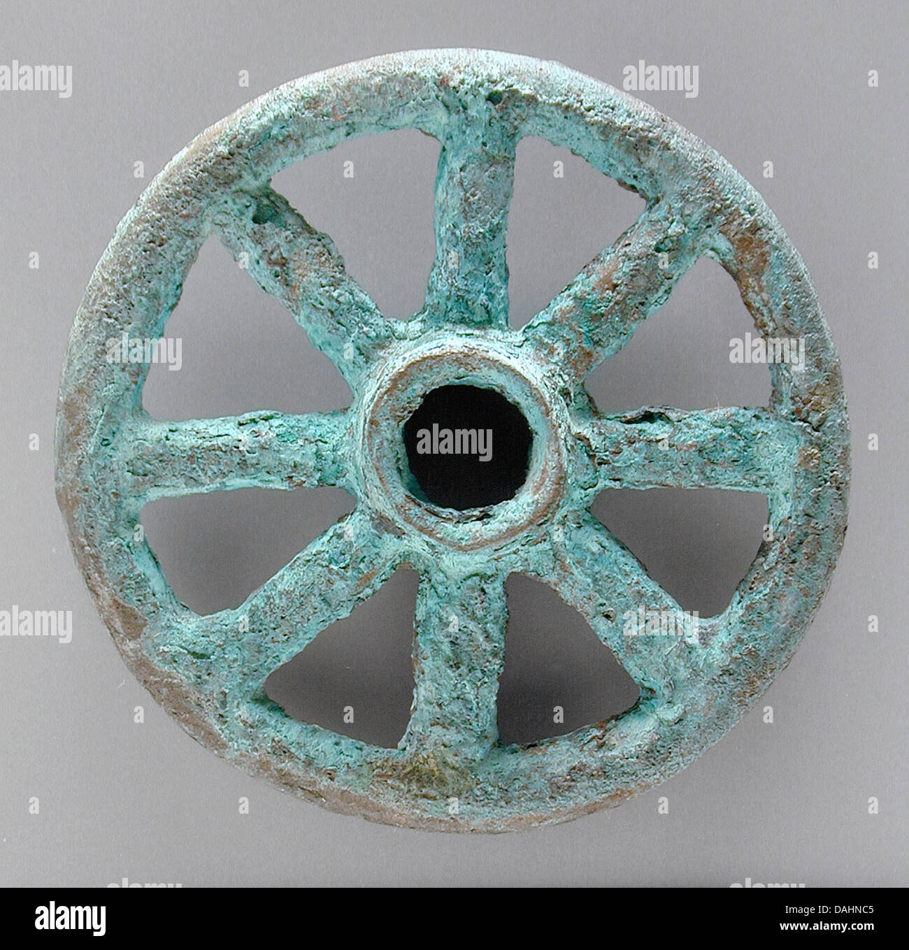 This model spoked wheel, crafted from metal, represents an ancient ...