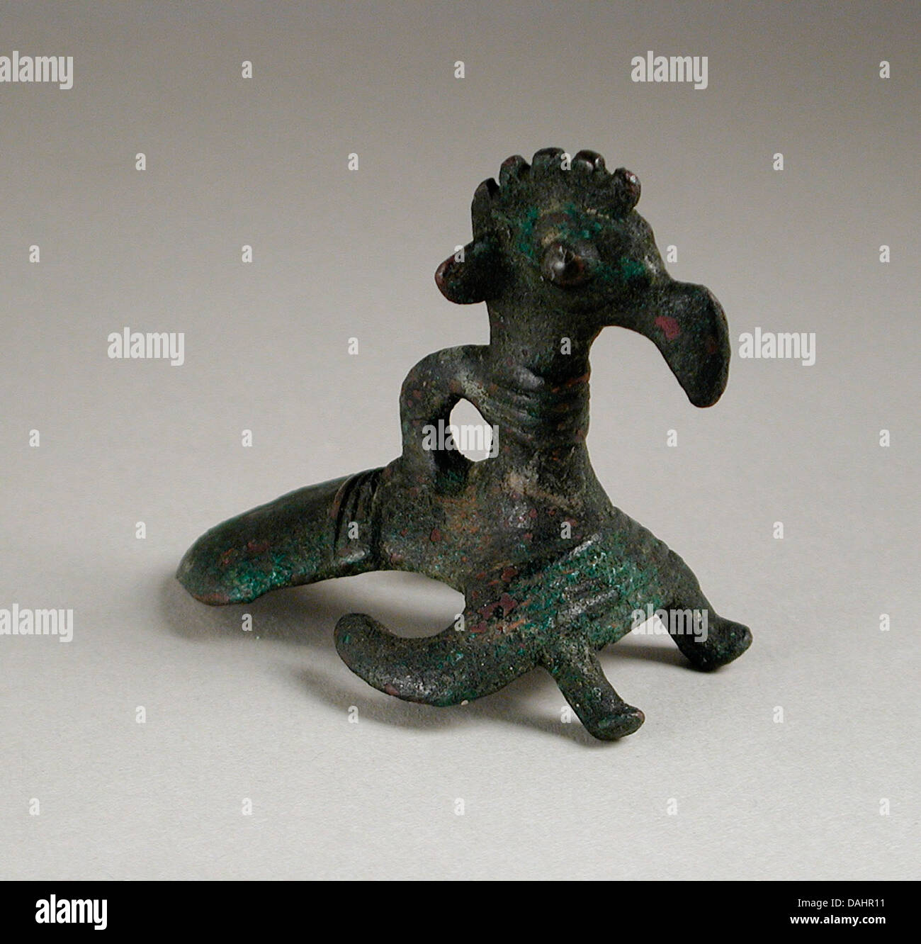 This pendant, crafted from bronze, is an example of ancient adornment ...