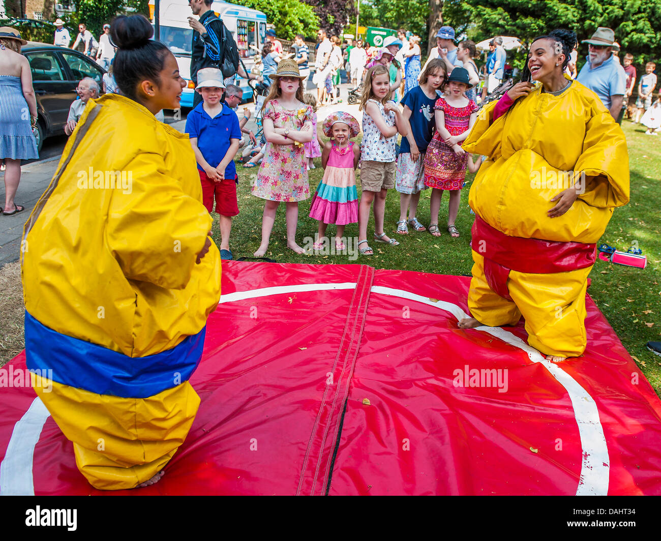London, UK. 14th July, 2013. Sunshine, Pimms, face painting and sumo ...