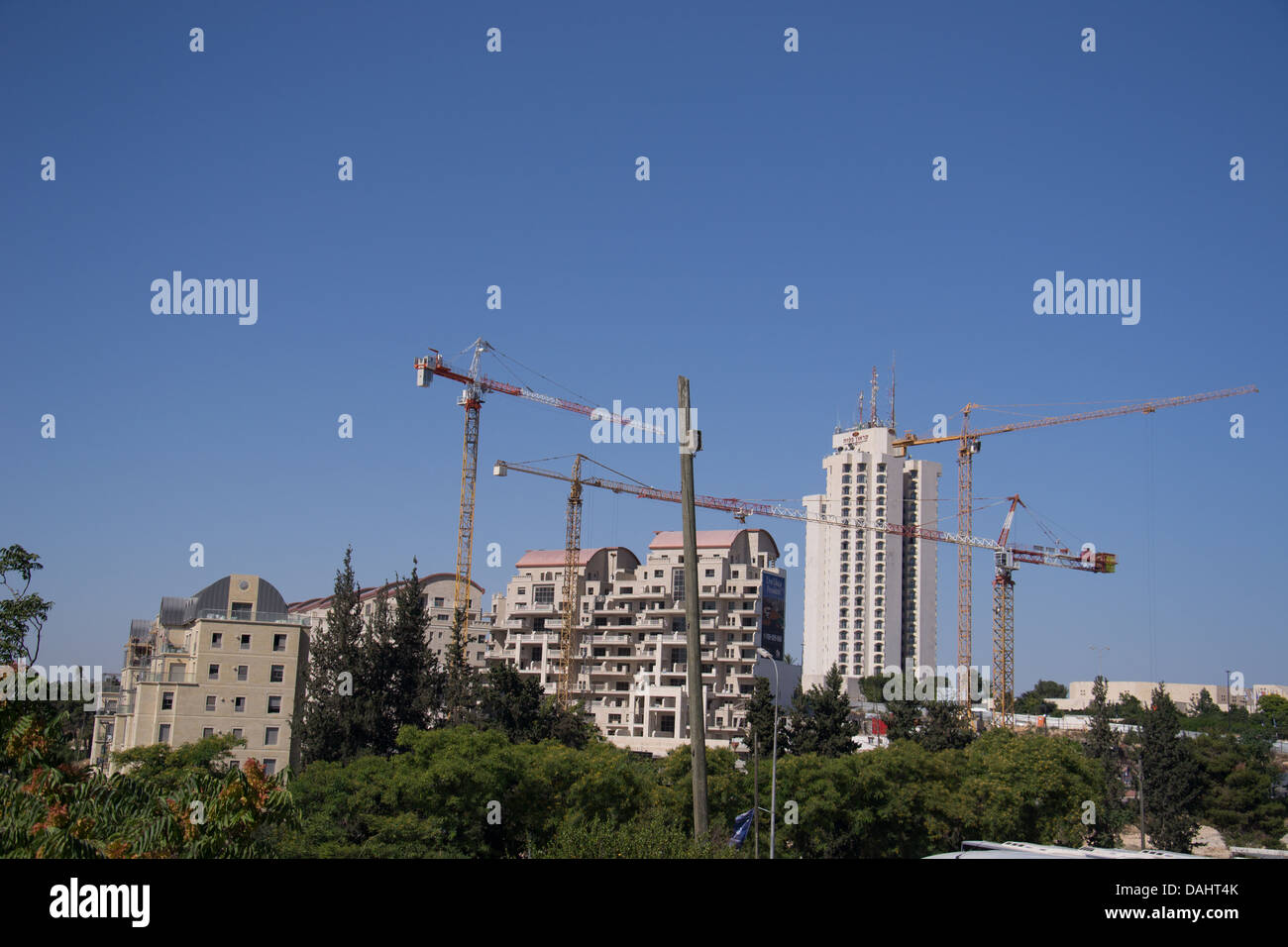 Construction cranes over residential buildings hi-res stock photography ...
