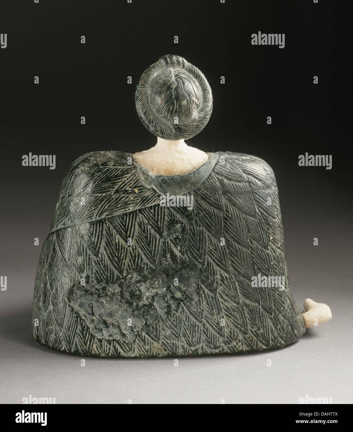 A seated female figure sculpture, illustrating cultural and artistic ...