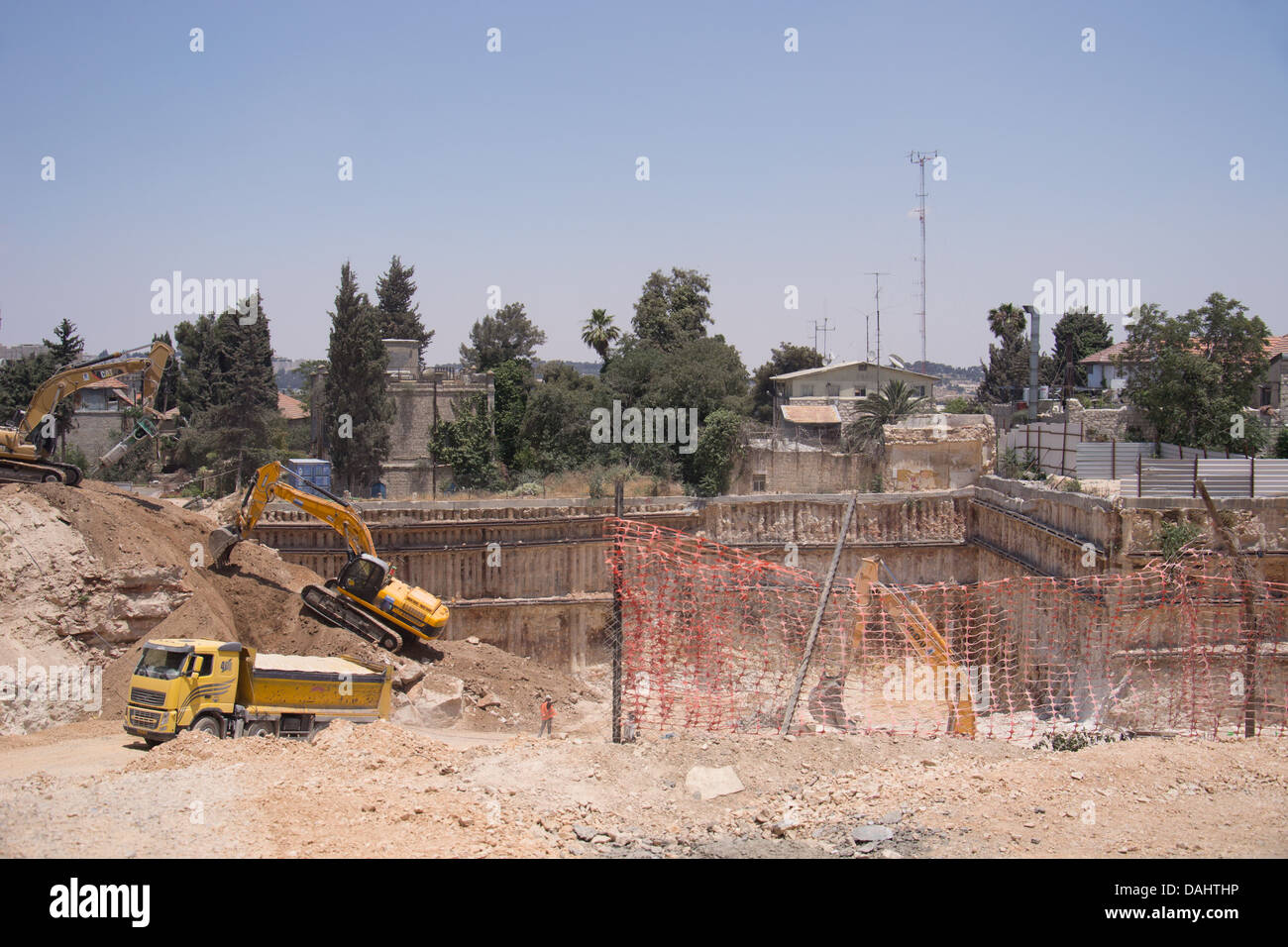 Two backhoes clearing a site after a building demolition Stock Photo ...