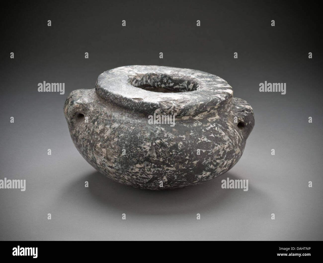 A ceramic squat vase featuring lug handles, showcasing functional and ...