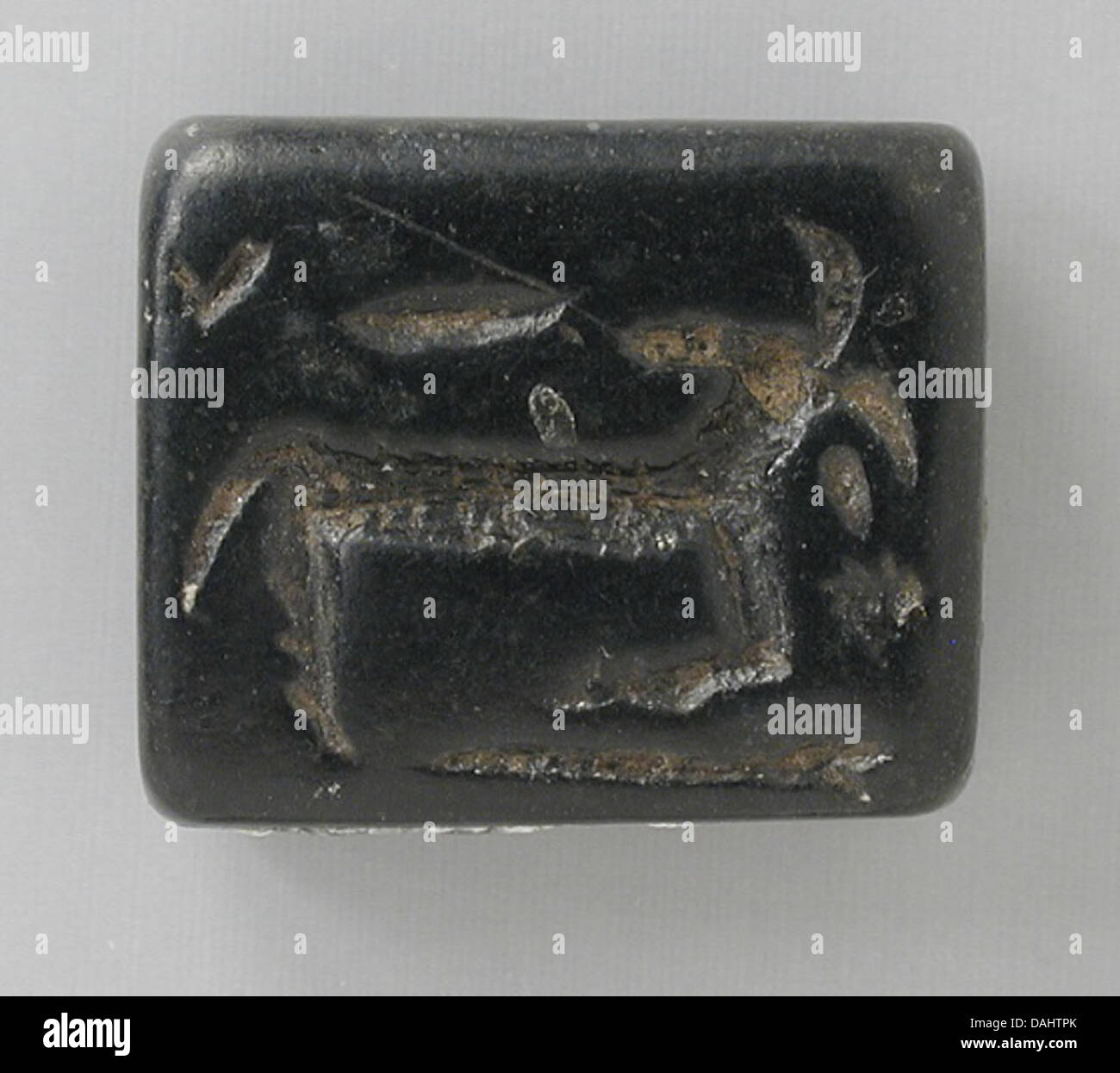 This stamp seal features engraved designs used in the ancient world for ...
