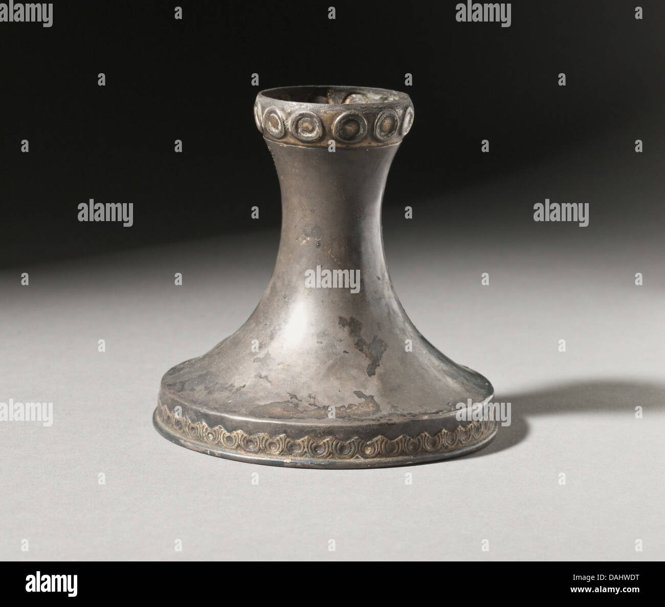 This bronze stand is a fine example of ancient craftsmanship, featuring ...