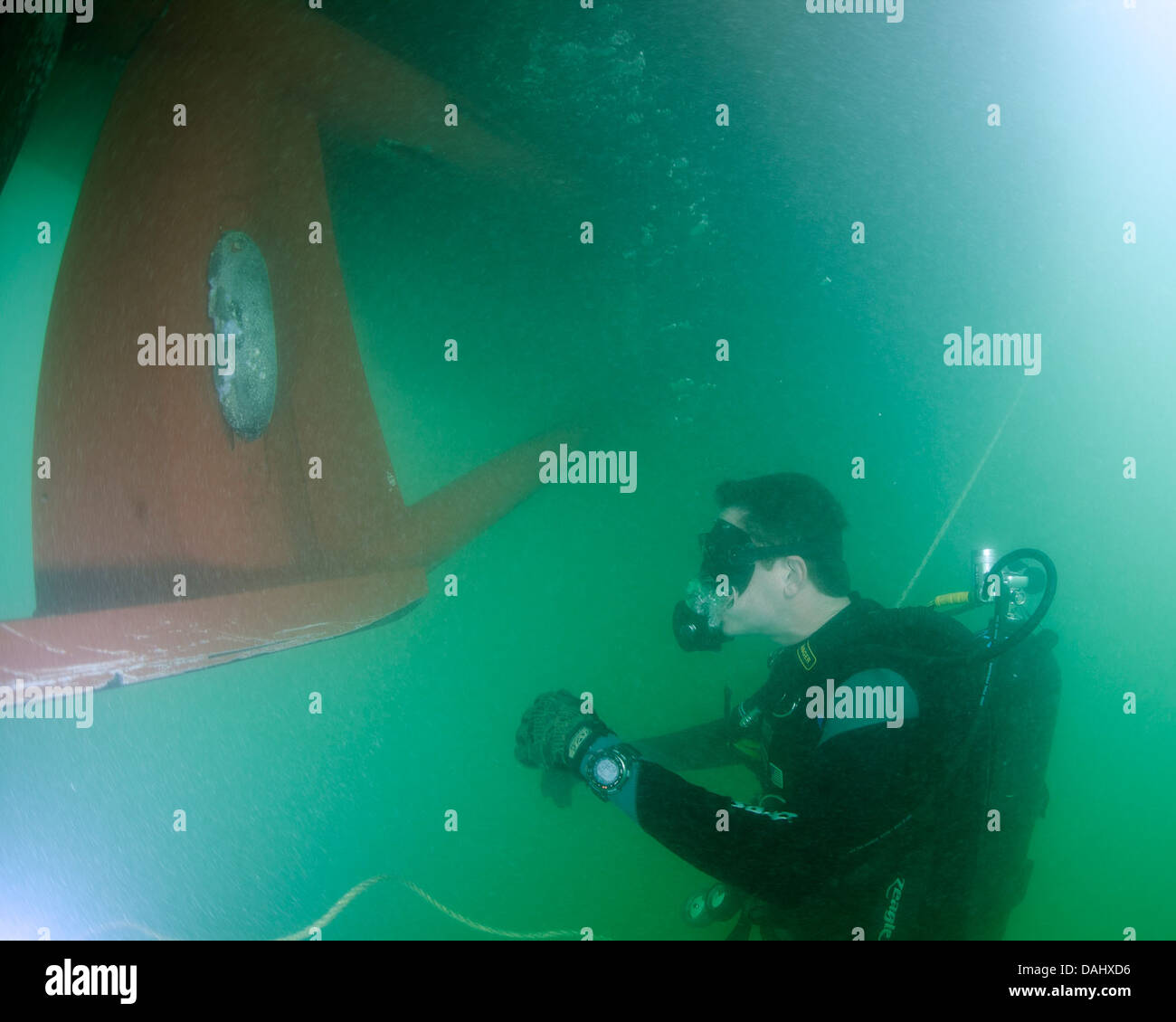 U.S. Navy Diver 3rd Class conducts an inspection dive at the Mina ...