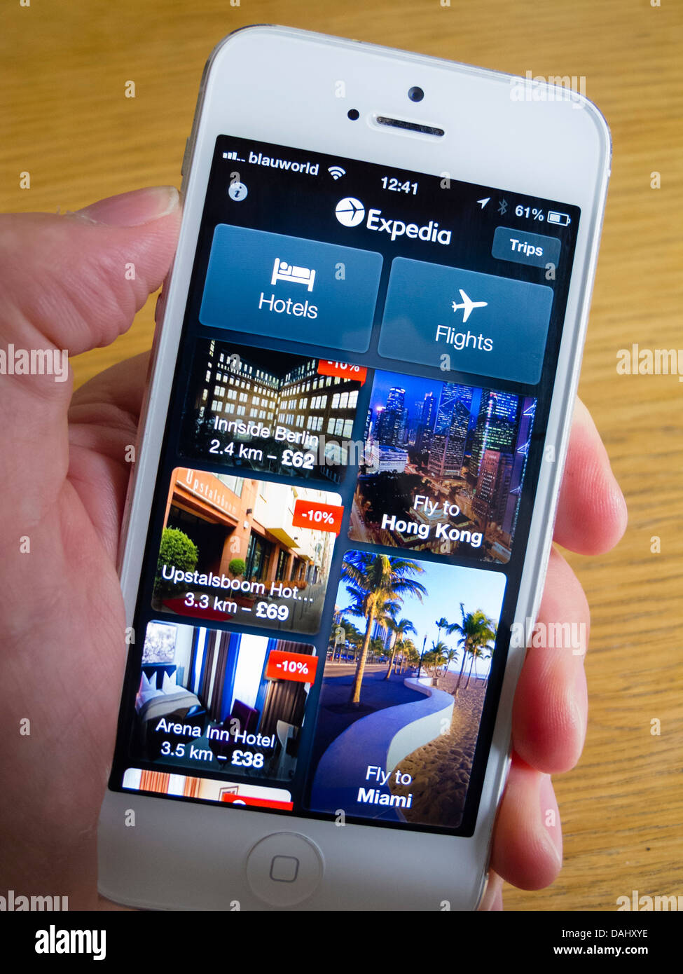 Using Expedia app to book travel on white iPhone 5 smartphone Stock ...