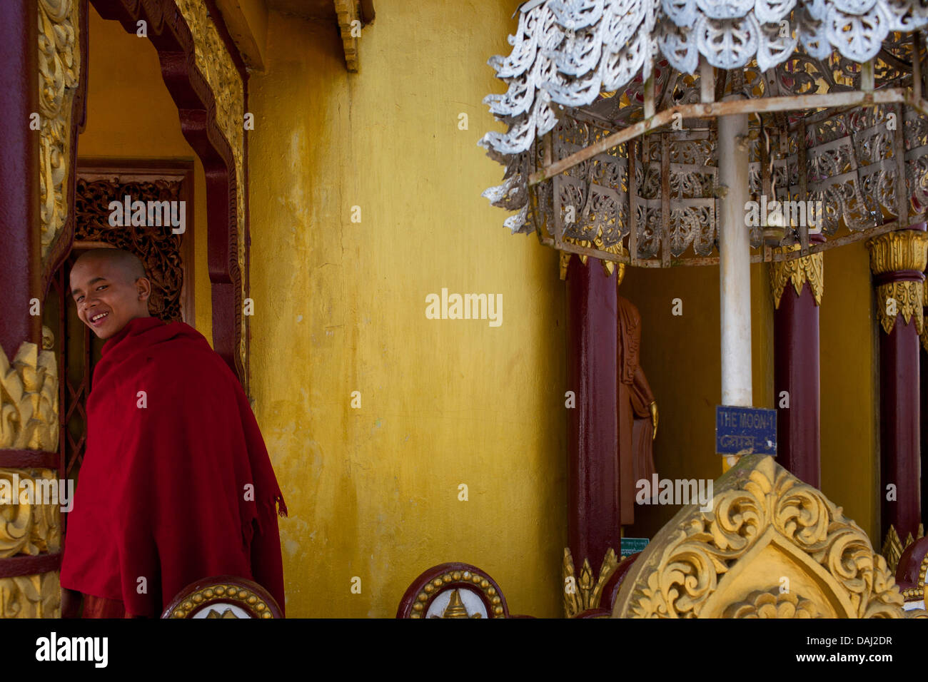 A smiling monk at the golden temple, a famous Buddhist monastery close ...