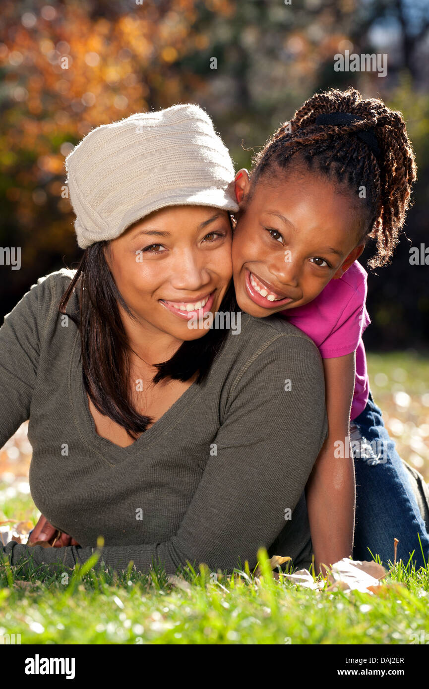 Happy African American mother and child having fun spending time together in a park Stock Photo ...