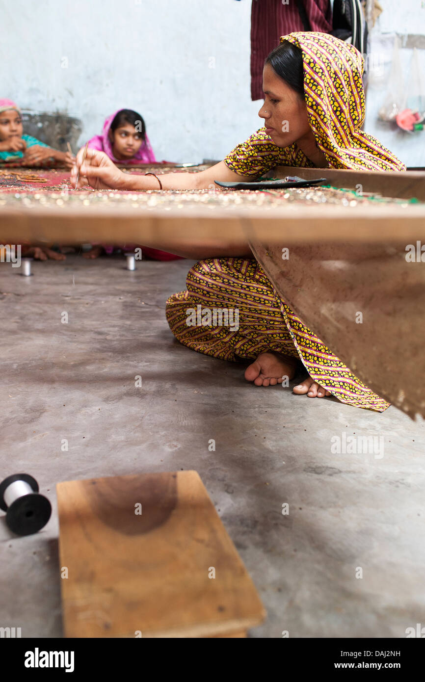 A woman works on details on a traditional Jamdani saree in Mirpur ...