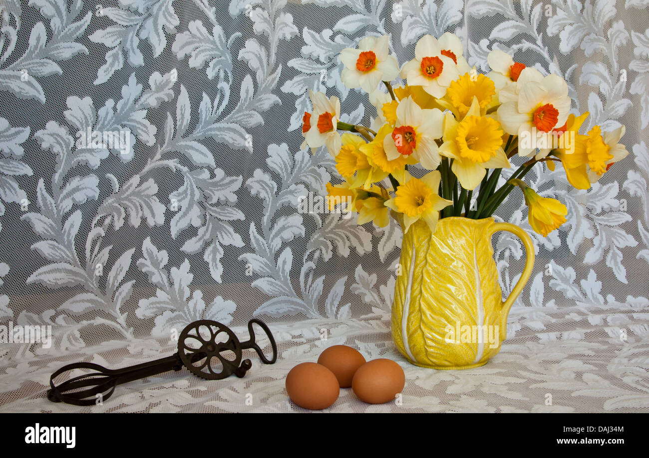 Colorful Container of spring Daffodil flowers in a yellow pitcher ...