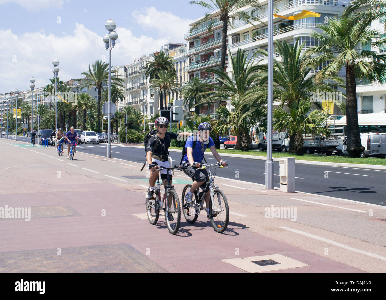 Two young men cycling along the promenade at Nice, France Stock Photo ...