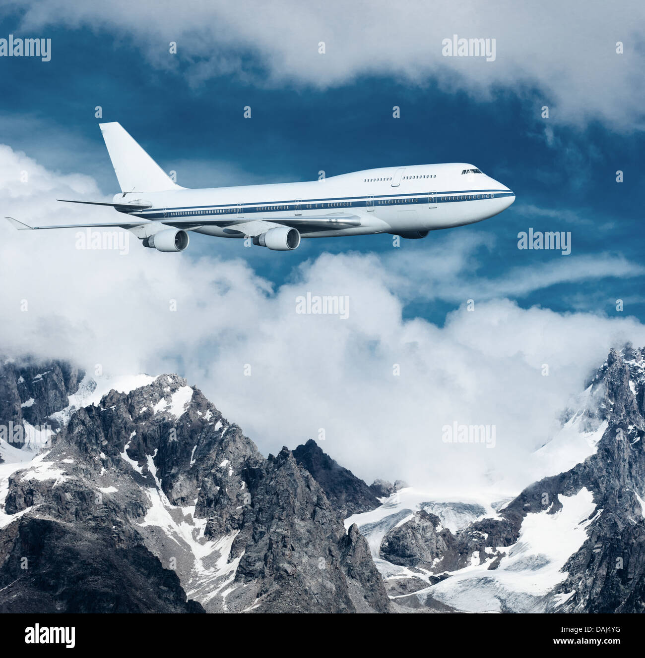 plane flying over the snow-capped mountains. passenger airplane in the clouds. travel by air ...