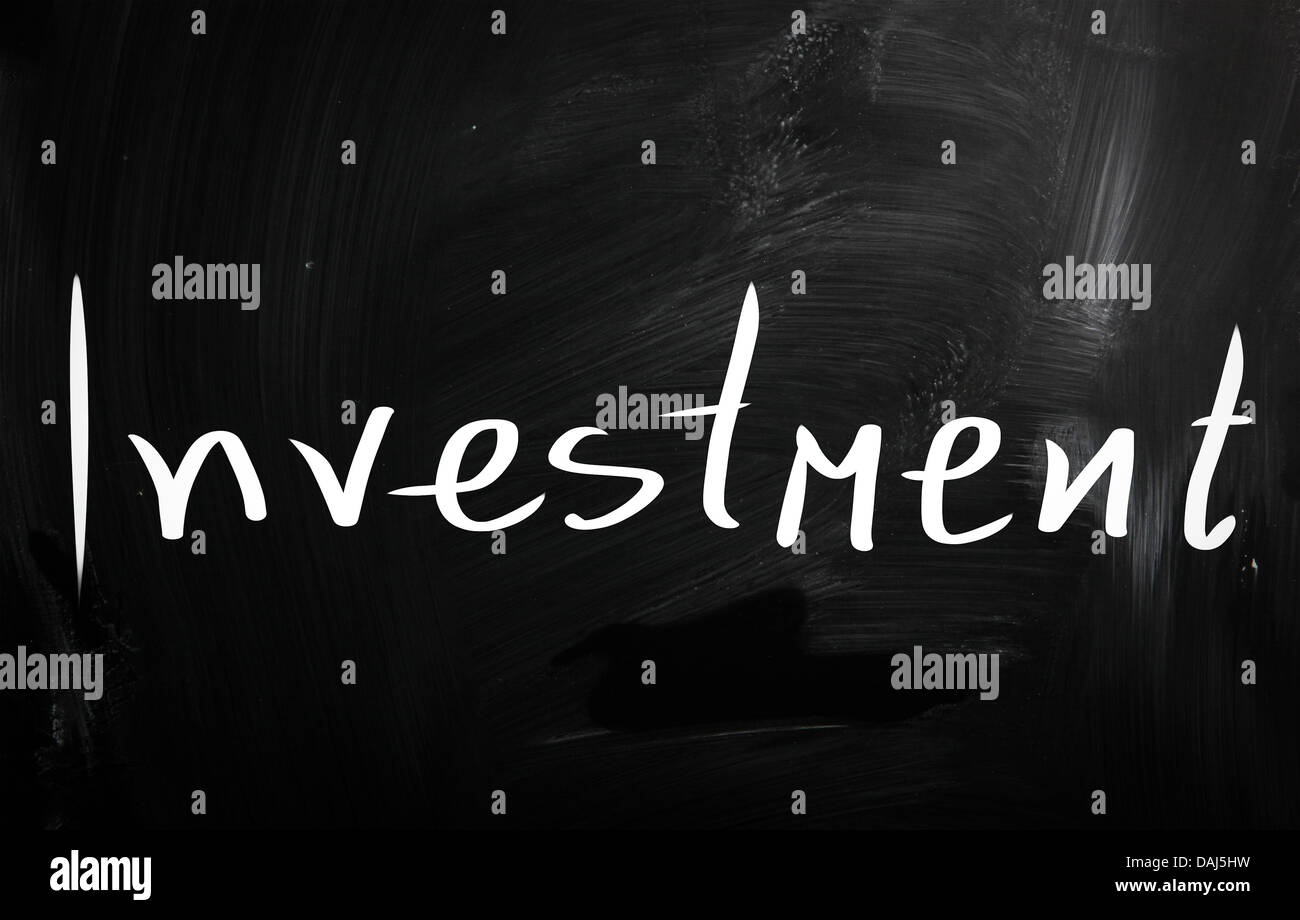 The word 'Investment' handwritten with white chalk on a blackboard ...