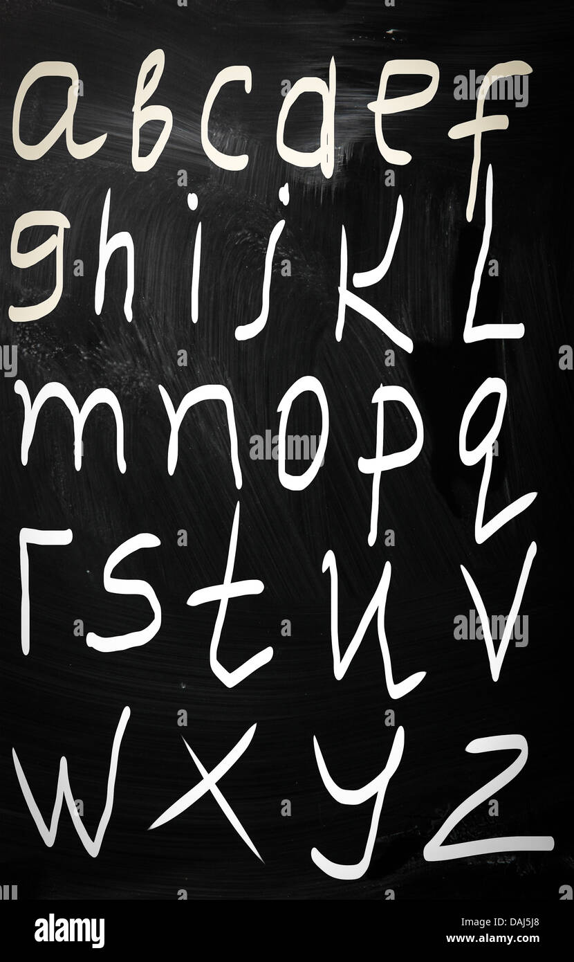 Complete english alphabet handwritten with white chalk on a blackboard ...