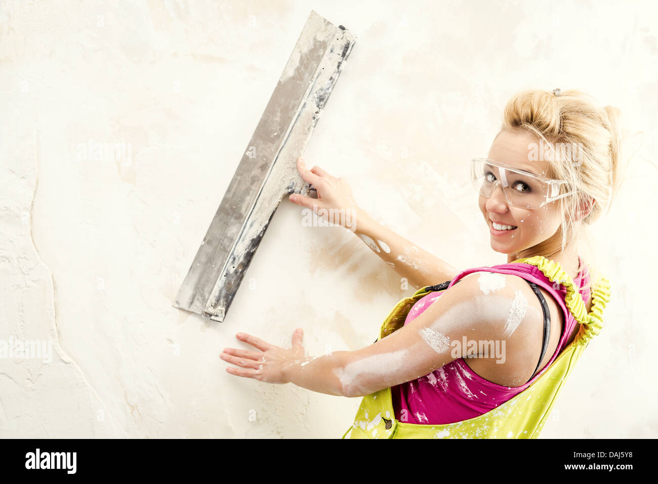 Female with putty knife working Stock Photo - Alamy