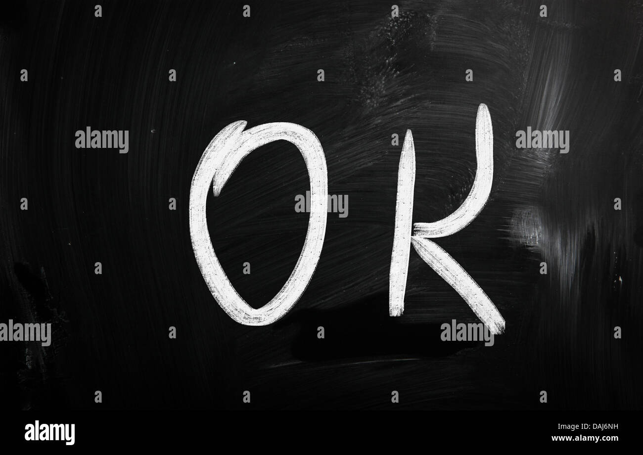 OK handwritten with white chalk on a blackboard Stock Photo - Alamy