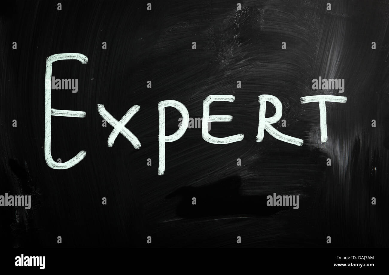 The word "Expert" handwritten with white chalk on a blackboard Stock ...