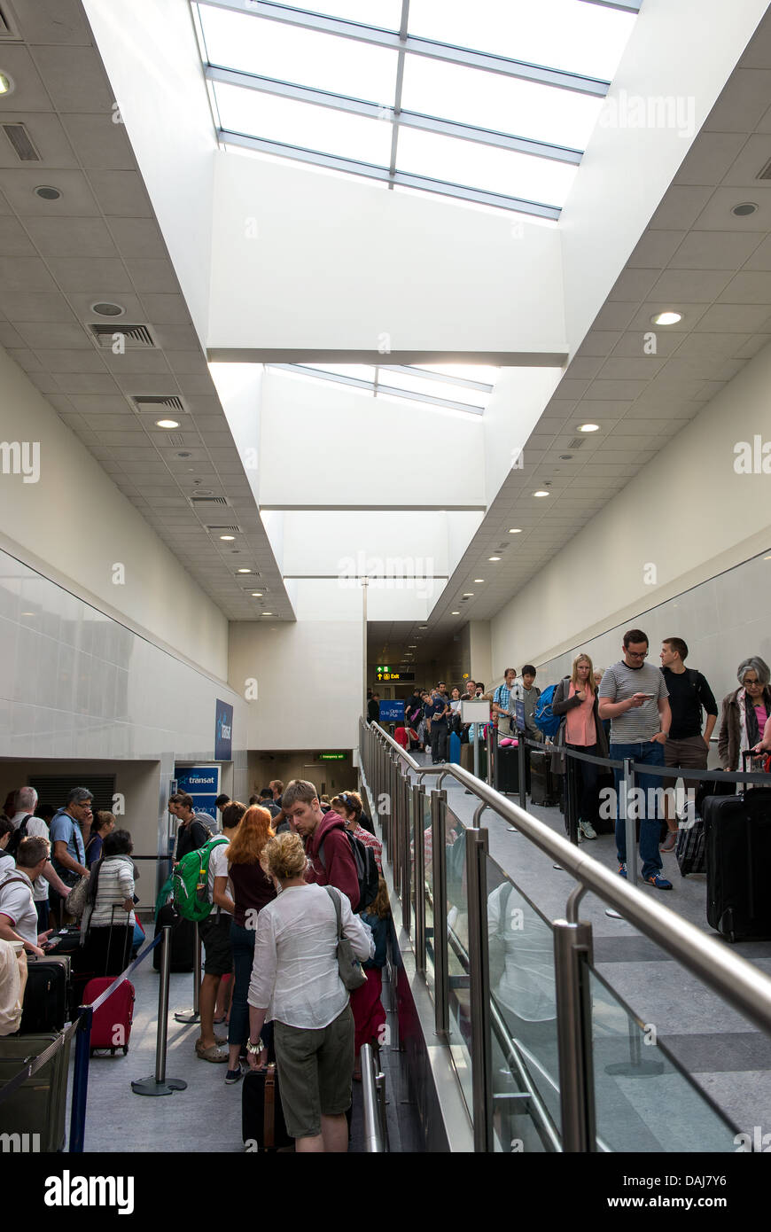 Passengers queue for baggage check-in and boarding pass check Stock ...