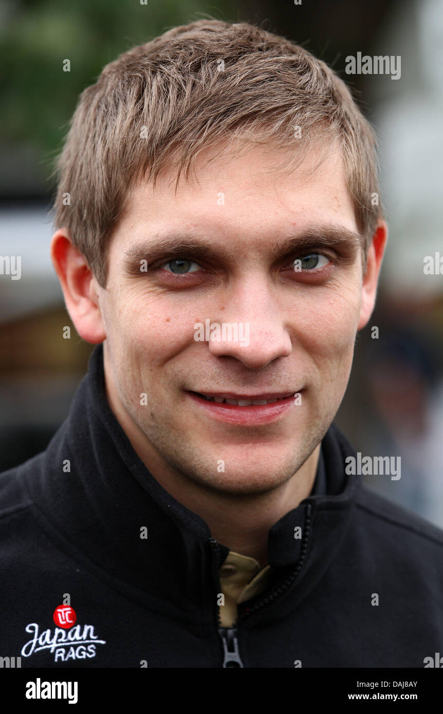 Russian Formula One driver Vitaly Petrov of Lotus Renault smiles during ...