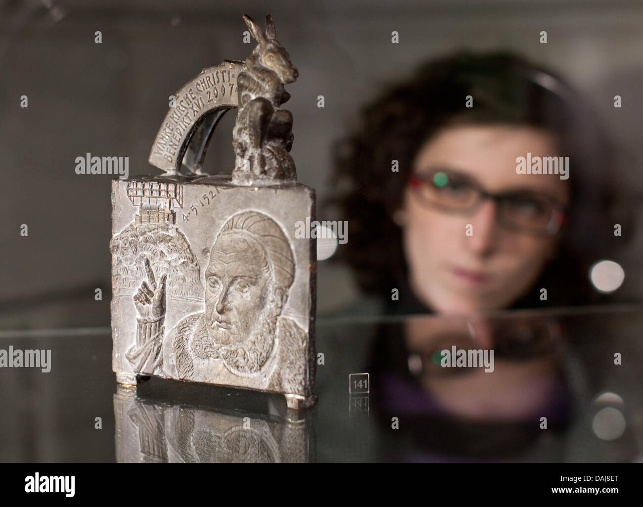 A eyes a medal 'Papal Donkey' (2009) by Bernd Goebel at an exhibition ...