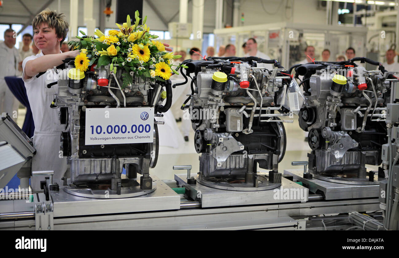 A Volkswagen employee decorates the ten millionth engine, a 1.4 TFSI ...