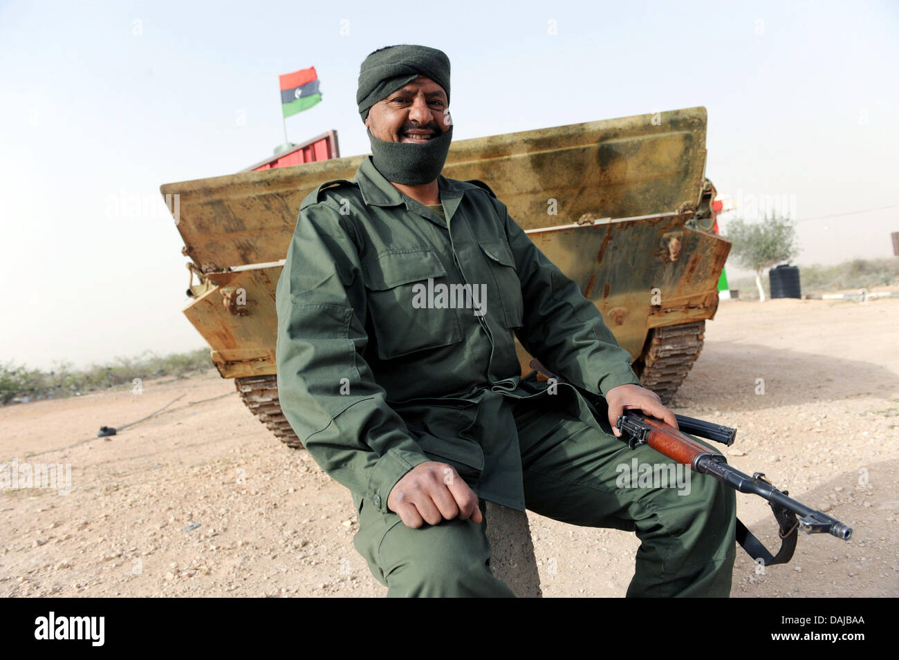 A member of the rebel army guards a tank near Tobruk, Libya. After a ...