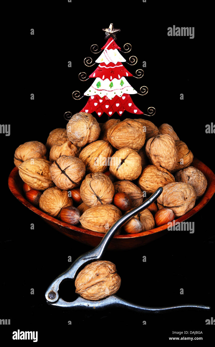 Wooden bowl full of Walnuts and Hazelnuts with nutcrackers and a pretty ...